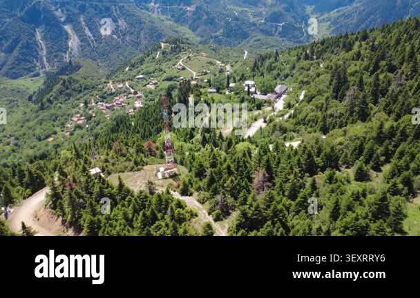 Aerial wide angle view of a traditional isolated village in a green ...