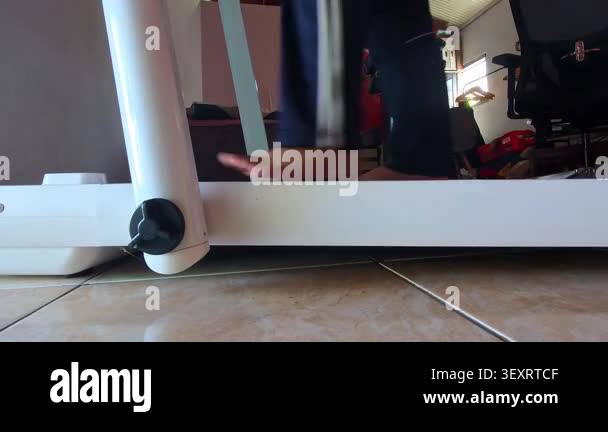 Timelapse Video of Low angle view of treadmill in use. Person walks ...