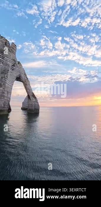 Sunrise over the ocean highlights Etretat France. The natural arches ...