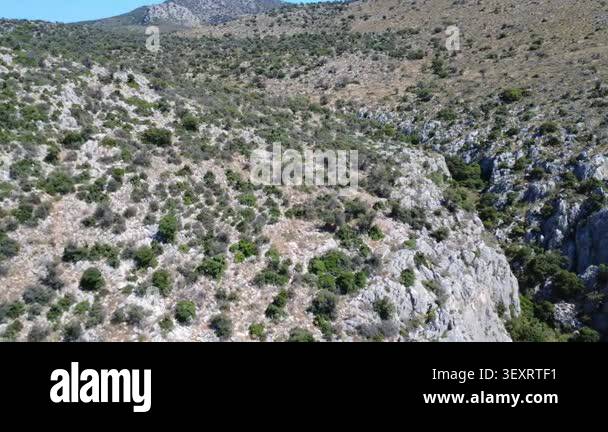 Aerial wide angle reveals a barren rocky canyon and an expansive ...
