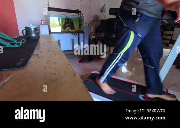 Timelapse Video of Person running barefoot on treadmill indoors. Room ...
