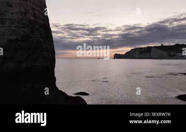View of Etretat France sea arches and white chalk cliffs. The tranquil ...
