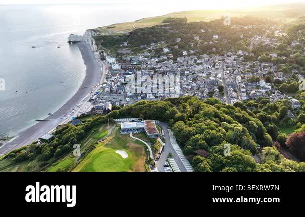 Aerial perspective shows Etretat France its famed chalk cliffs sweeping ...