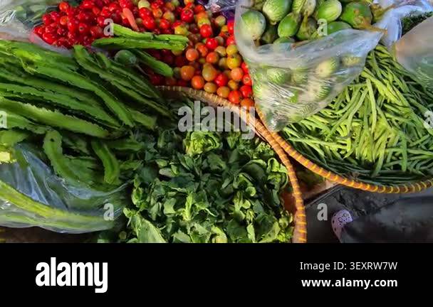 Video of Fresh vegetables in colorful baskets at a vibrant market stall ...