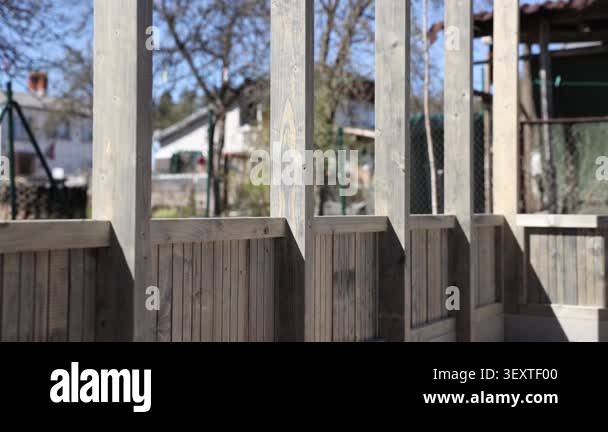 Gentle pan moves across interior framing, grey stained posts, tongue ...