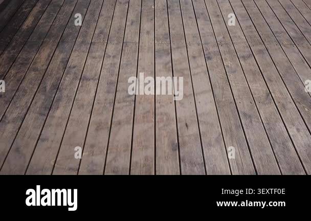 Parallel grooved wooden planks show screw lines, narrow gaps, and ...