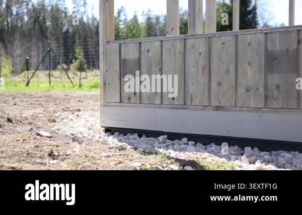 Slow low angle tracking shows weathered lower wall panels, painted base ...