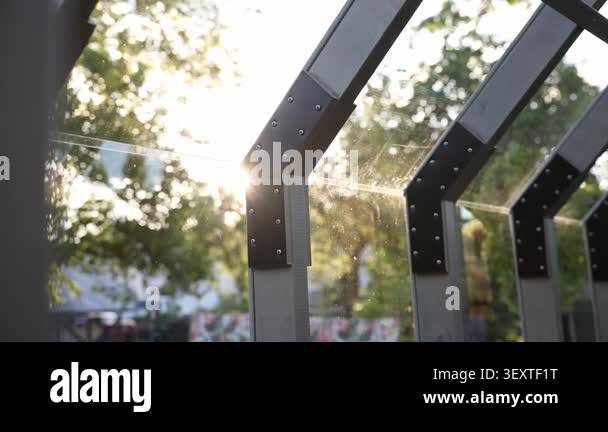 Close up shows slanted wooden rafters, black metal brackets with rivets ...