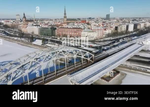Aerial view of central Riga, Latvia shows frozen Daugava, steel arch ...