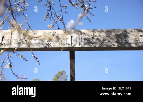Horizontal timber beam with elongated keyhole slots and a vertical post ...