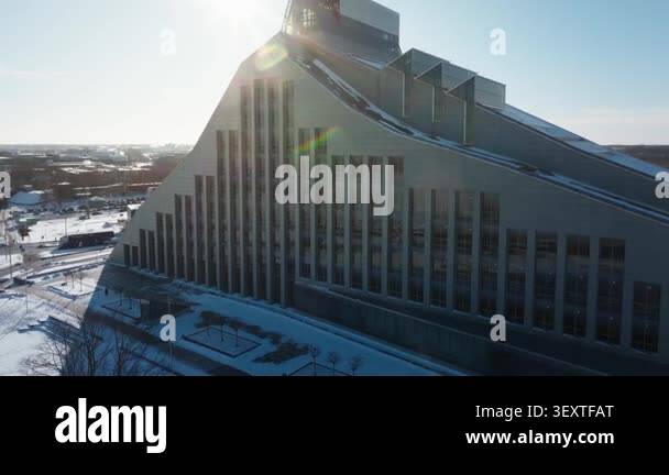 Aerial drone pans up the National Library of Latvia in Riga, showing ...