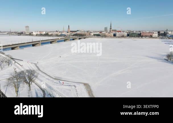 Aerial view of Riga in winter shows frozen Daugava River, Old Town ...