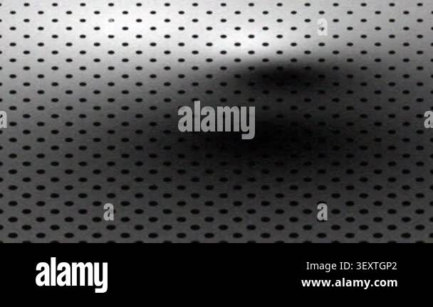 Animated abstract metallic background loop featuring a perforated grid ...
