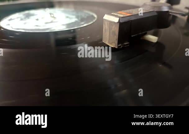 Old vinyl record player spinning retro music disc in vintage style ...