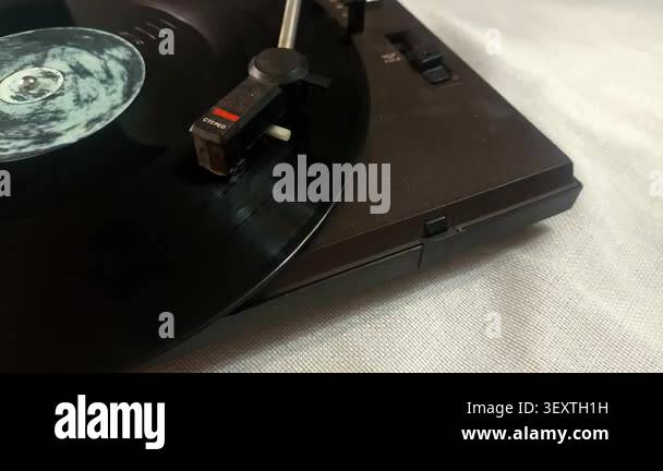 Old vinyl record player spinning retro music disc in vintage style ...