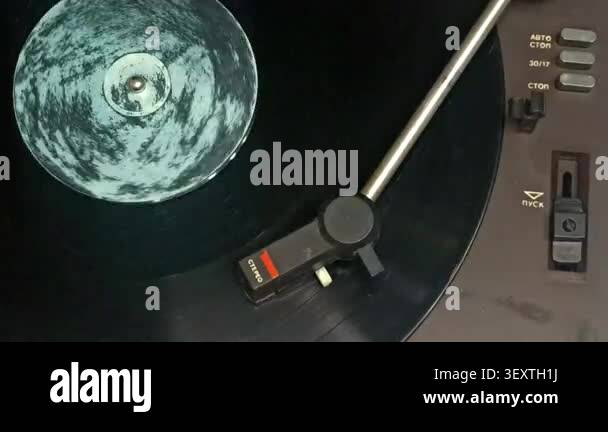 Old vinyl record player spinning retro music disc in vintage style ...