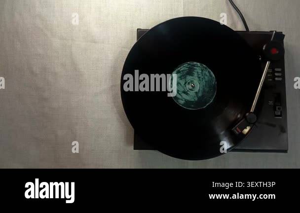 Old vinyl record player spinning retro music disc in vintage style ...