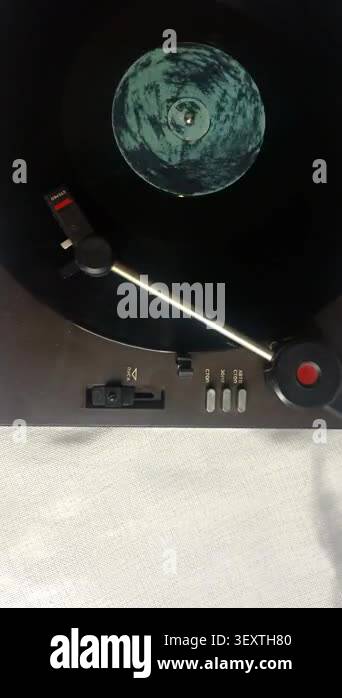 Old vinyl record player spinning retro music disc in vintage style ...