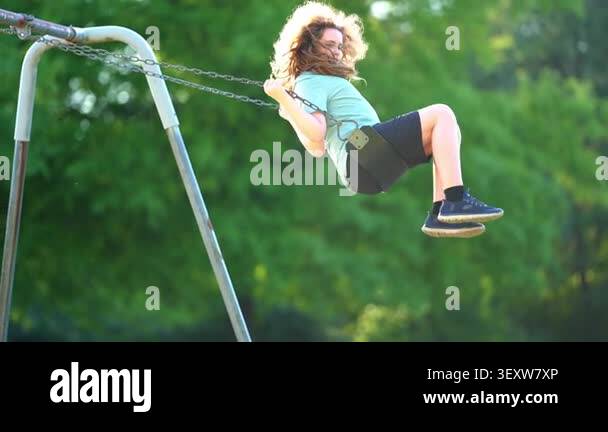 Child swinging in summer park. Happy child on swing outdoors. Active ...