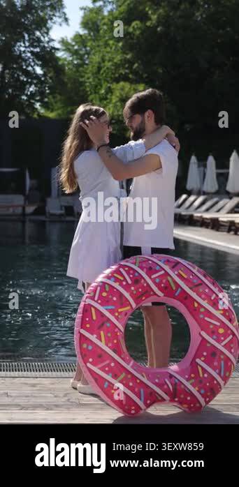 Young couple embracing and looking at each other affectionately near a ...