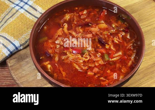 Hot red borscht in clay bowl on round oak stand Stock Video Footage - Alamy