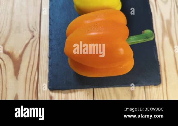 Multicolored bell peppers on flat black slate plate, top view Stock ...