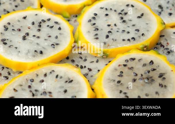 Exotic tropical fruit background with round dragon fruit pitaya slices ...
