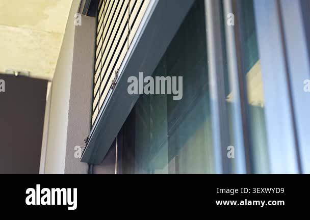 Exterior window blinds automatically closing over a large apartment ...