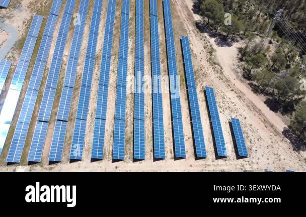 Aerial view of a solar farm with photovoltaic panels generating clean ...