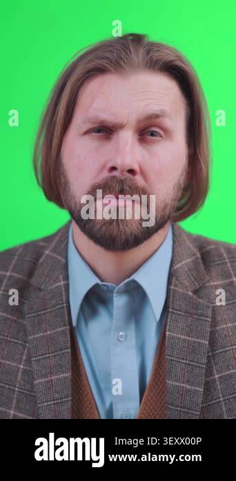 Man smiles and expresses different emotions in a green chroma ...