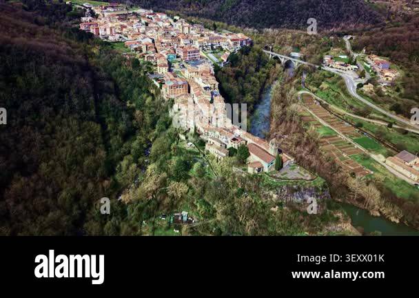Drone flight above Castellfollit de la Roca with river valley and ...