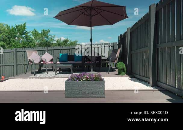 Outdoor patio with lounge furniture and umbrella. Soft lighting ...