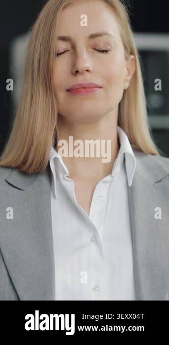 Woman in office attire practices breath meditation at a desk during ...