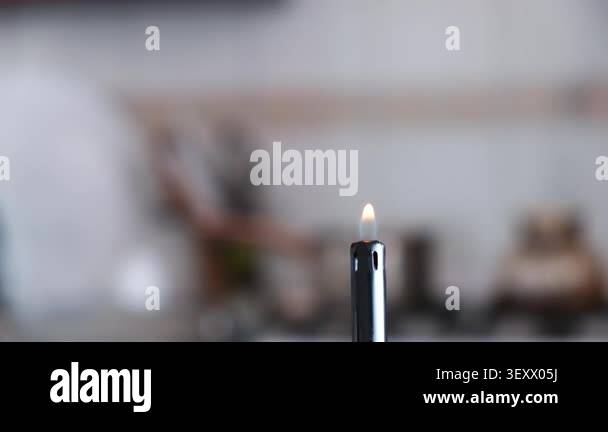 A lighter burns softly in the kitchen while a warm light fills the ...