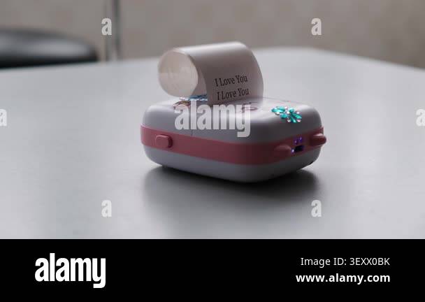 A small printer prints notes and stickers with sweet messages. It sits ...