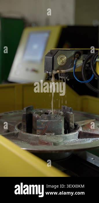 Industrial machining process with coolant flowing over metal component ...