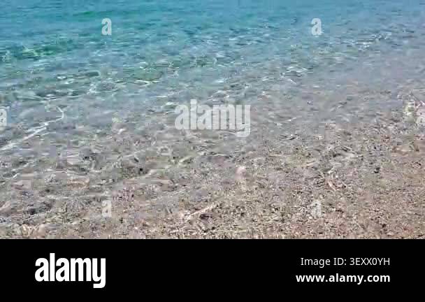 Close up background of crystal clear, transparent turquoise sea water ...
