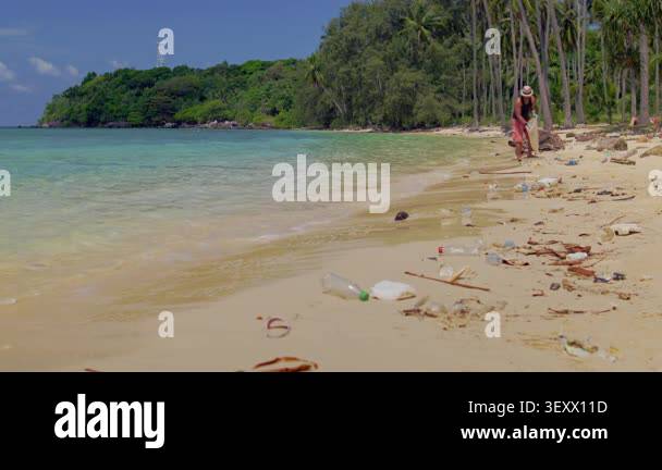 Beach Cleanup Activity as a Man Removes Trash from White Sand and ...
