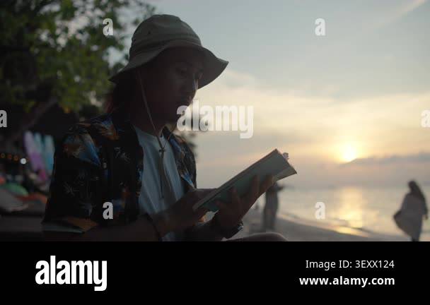 Book Lover Reading on a Scenic Beach in Sunset, Representing Coastal ...