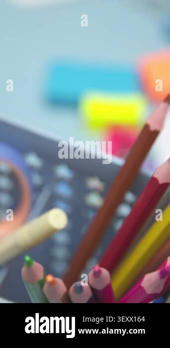 Hand Returning Colored Pencils to a Pencil Case on a Light Blue Desk ...