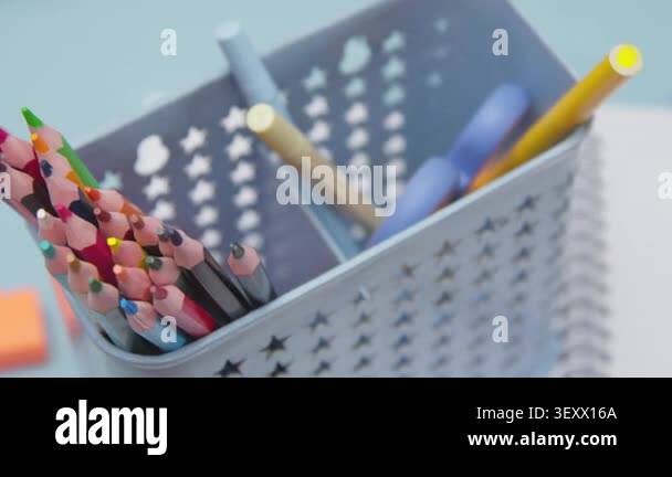Hand Picking Colored Pencils from a Light Blue Pencil Case on a Desk ...