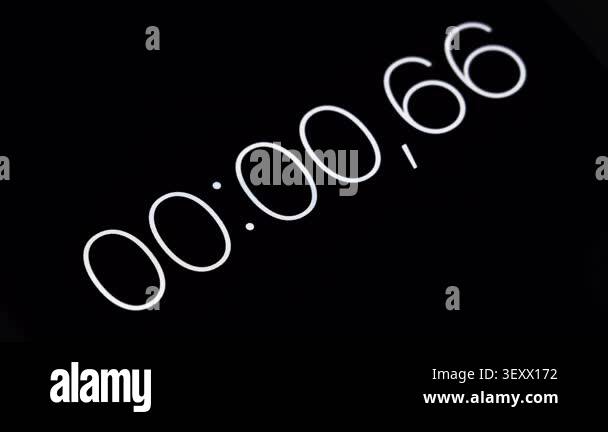 Digital timer counts from zero to ten seconds on a black screen ...