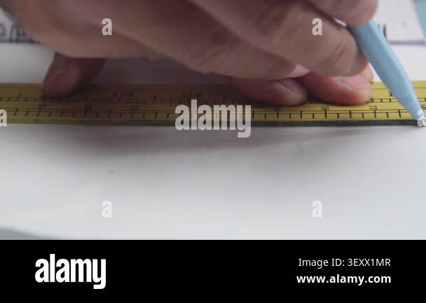 Macro Shot of Drawing a Straight Line with a Pen and Ruler on White ...