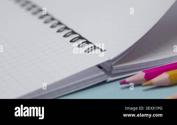 Close Up of a Hand Opening an Exercise Book on a Desk, Representing ...