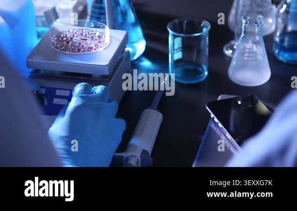 scientist in protective uniform with microscope in laboratory, closeup ...