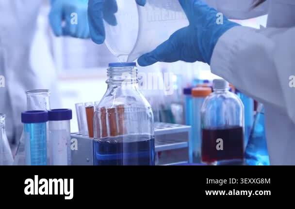 scientist in protective mask and gloves holding test tubes in ...