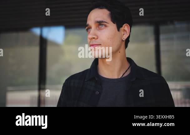 Young man in modern building environment. Smiling and positive student ...