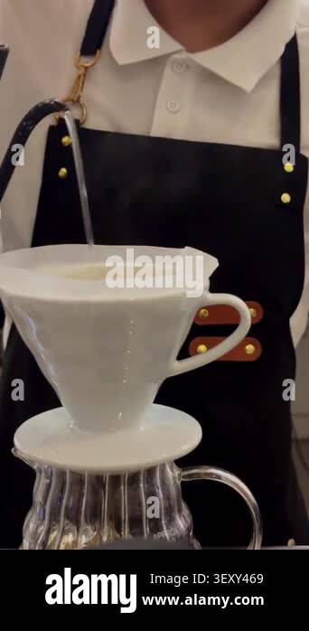 Close up of specialty coffee brewing process using two V60 ceramic ...