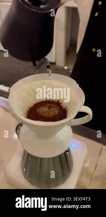 Close up of specialty coffee brewing process using two V60 ceramic ...