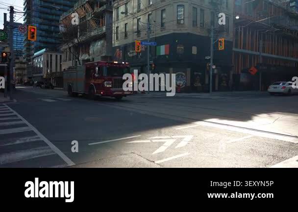 fire truck responding through downtown city intersection with urban ...